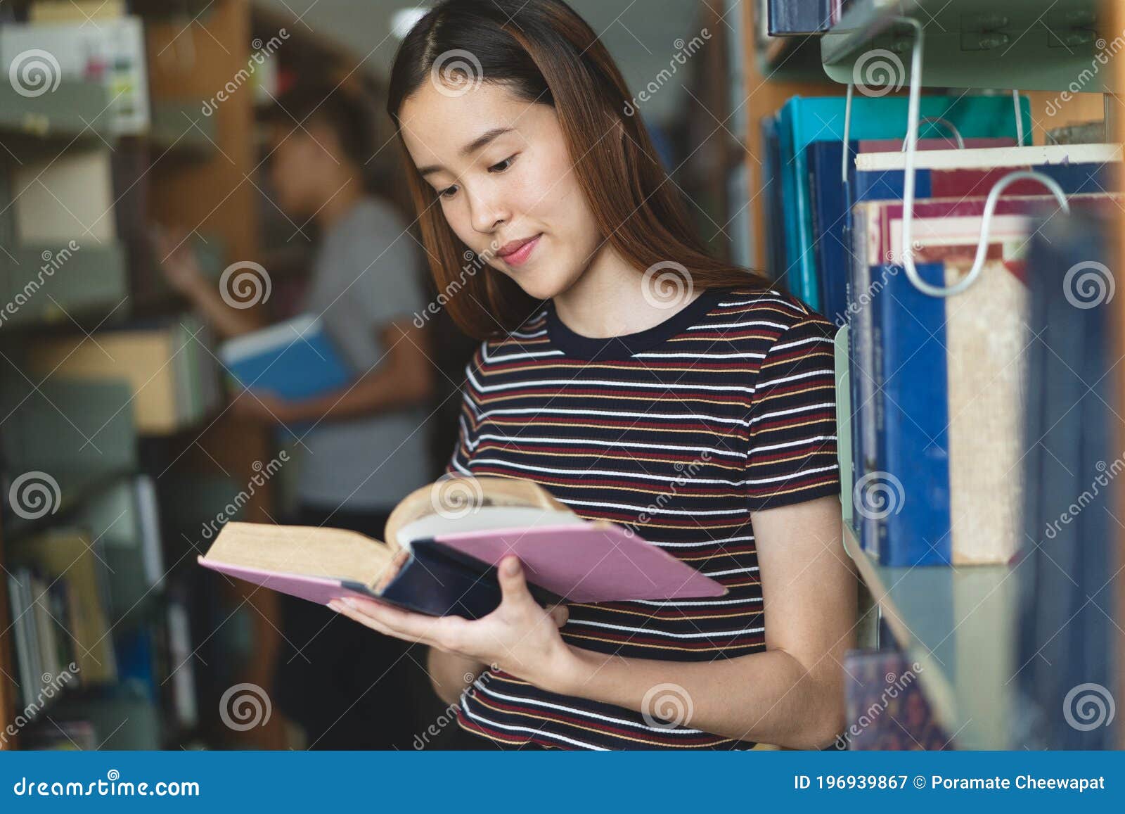 Student Learning in Library. Young Woman Read Book in Library for Doing ...