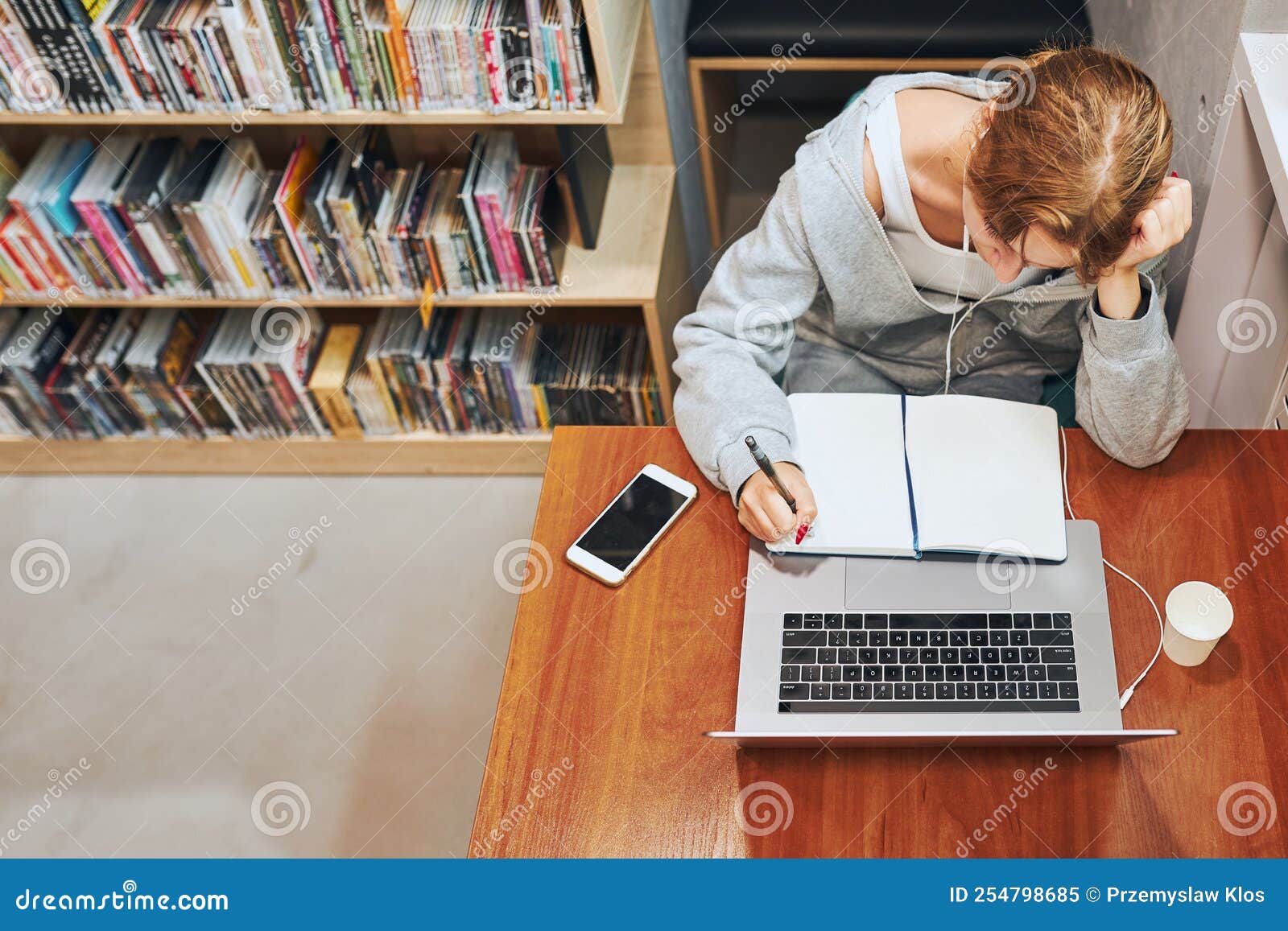 Student Learning in University Library. Young Woman Reading Textbook ...