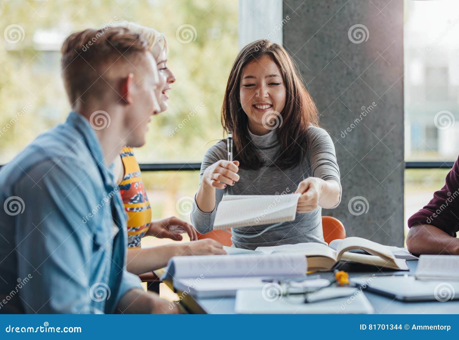 Student at Library Sharing Notes for School Assignment Stock Photo ...