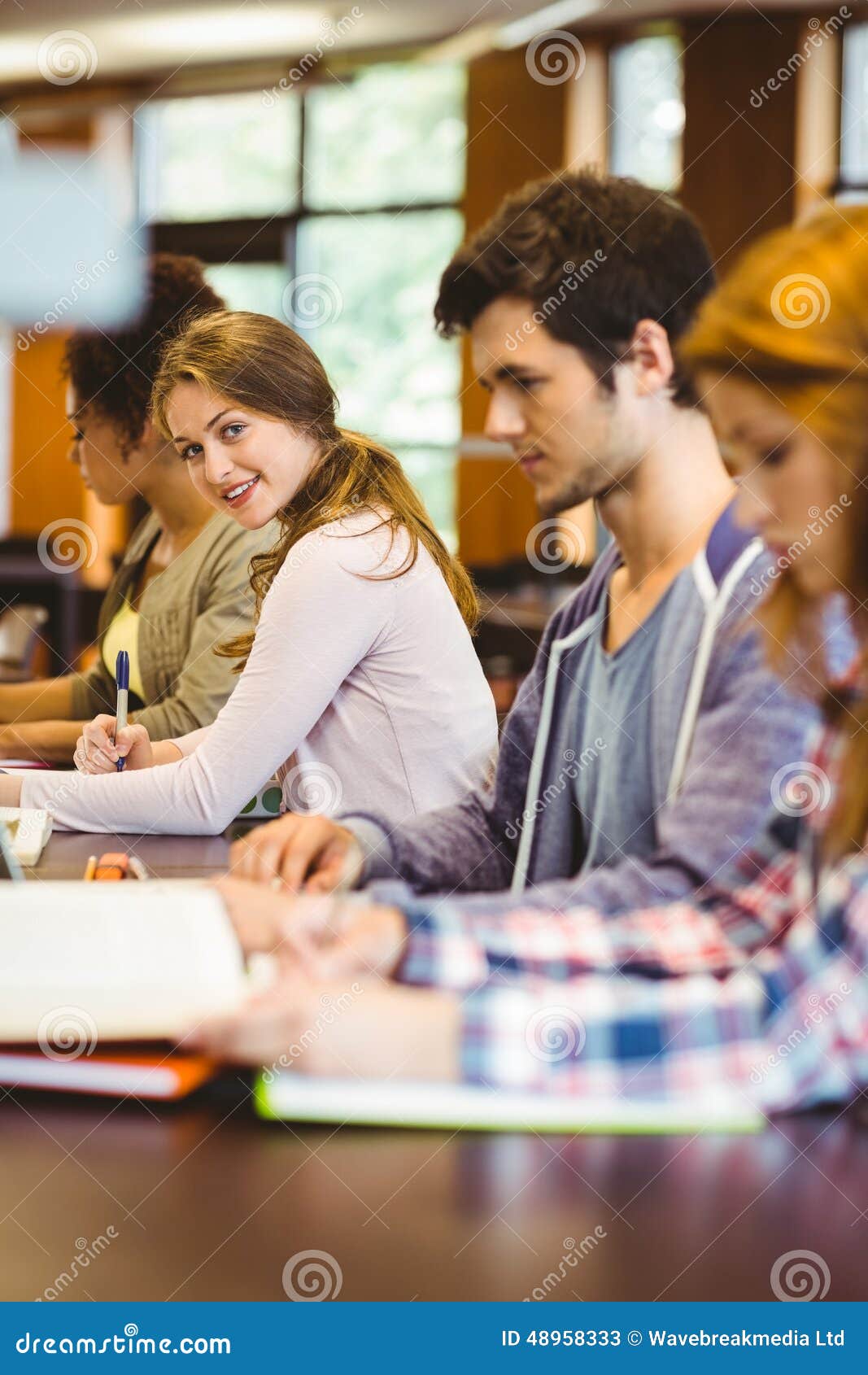 Student Looking at Camera while Studying with Classmates Stock Image ...