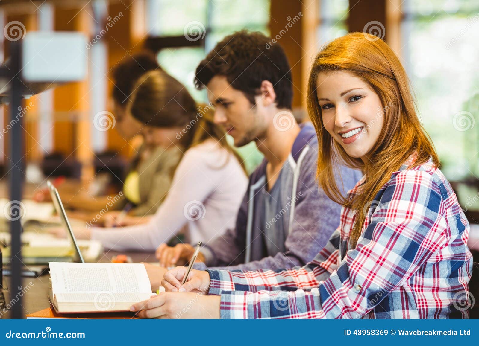 Student Looking at Camera while Studying with Classmates Stock Image ...