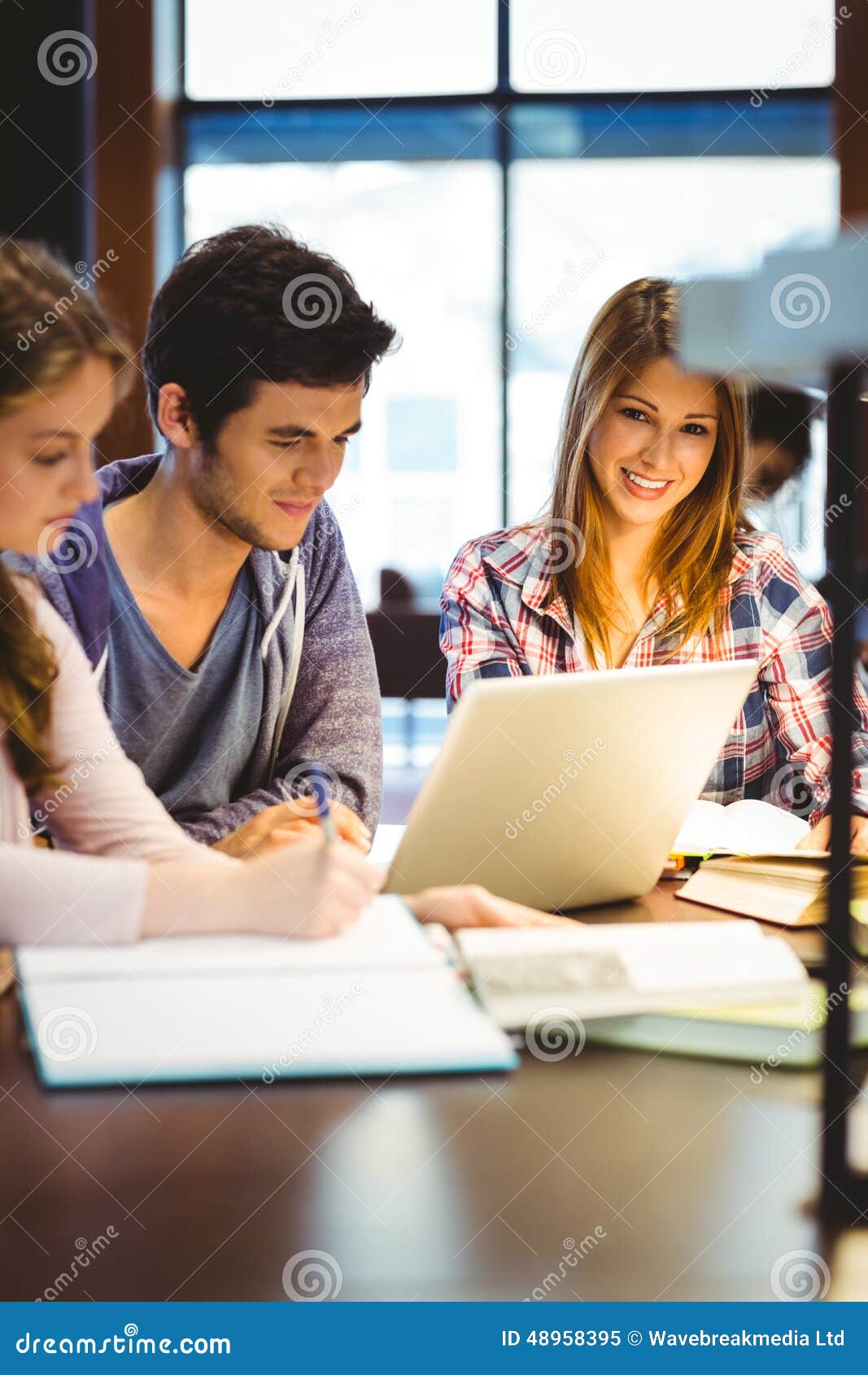 Student Looking at Camera while Studying with Classmates Stock Image ...