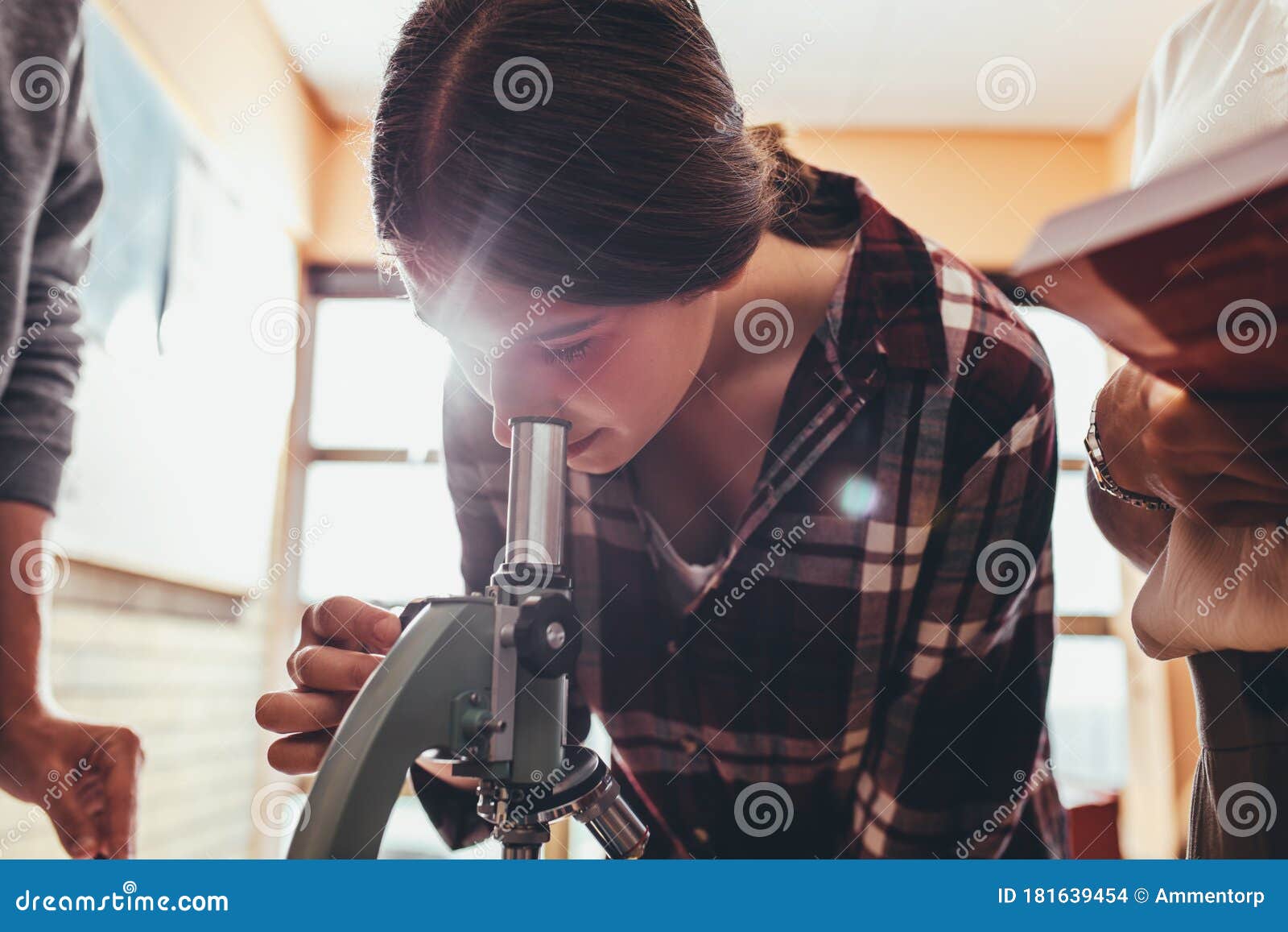 Student Looking through Microscope in Biology Class Stock Photo - Image ...
