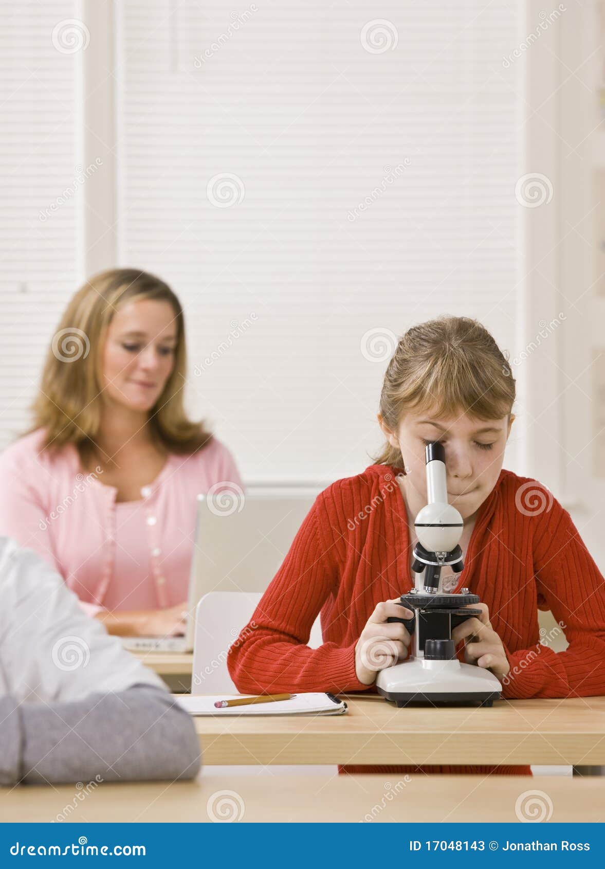 Student Looking into Microscope in Classroom Stock Image - Image of ...