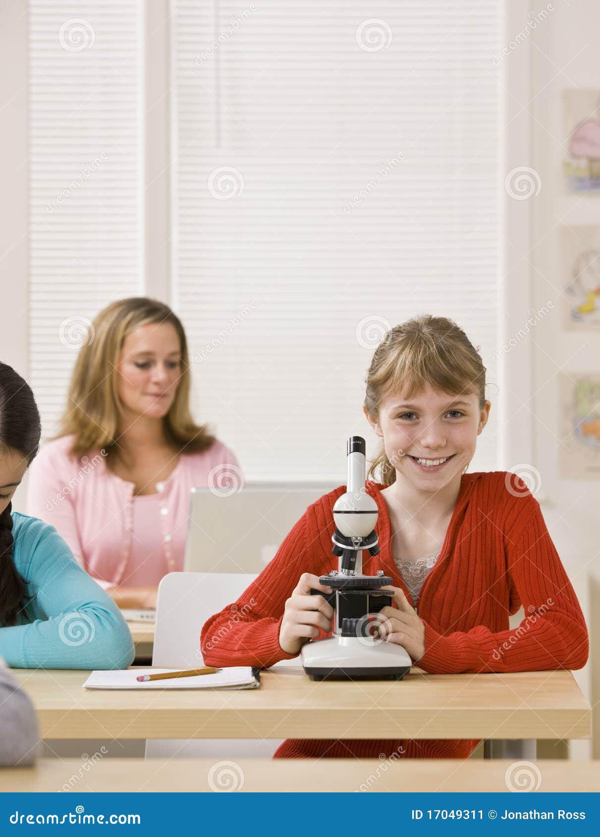 Student Looking into Microscope in Classroom Stock Image - Image of ...