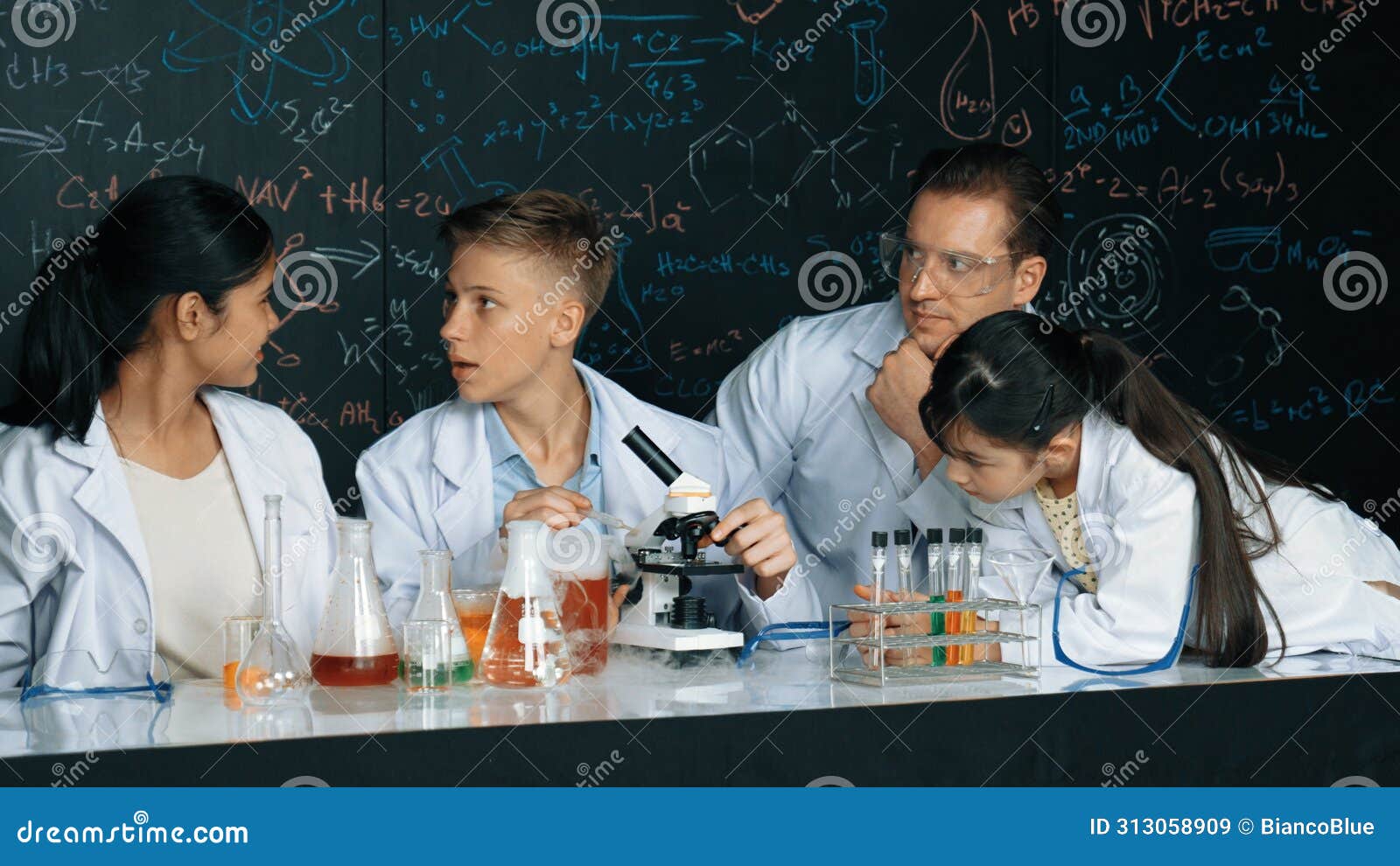 Student Looking Under Microscope while Cute Girl Inspect Sample ...