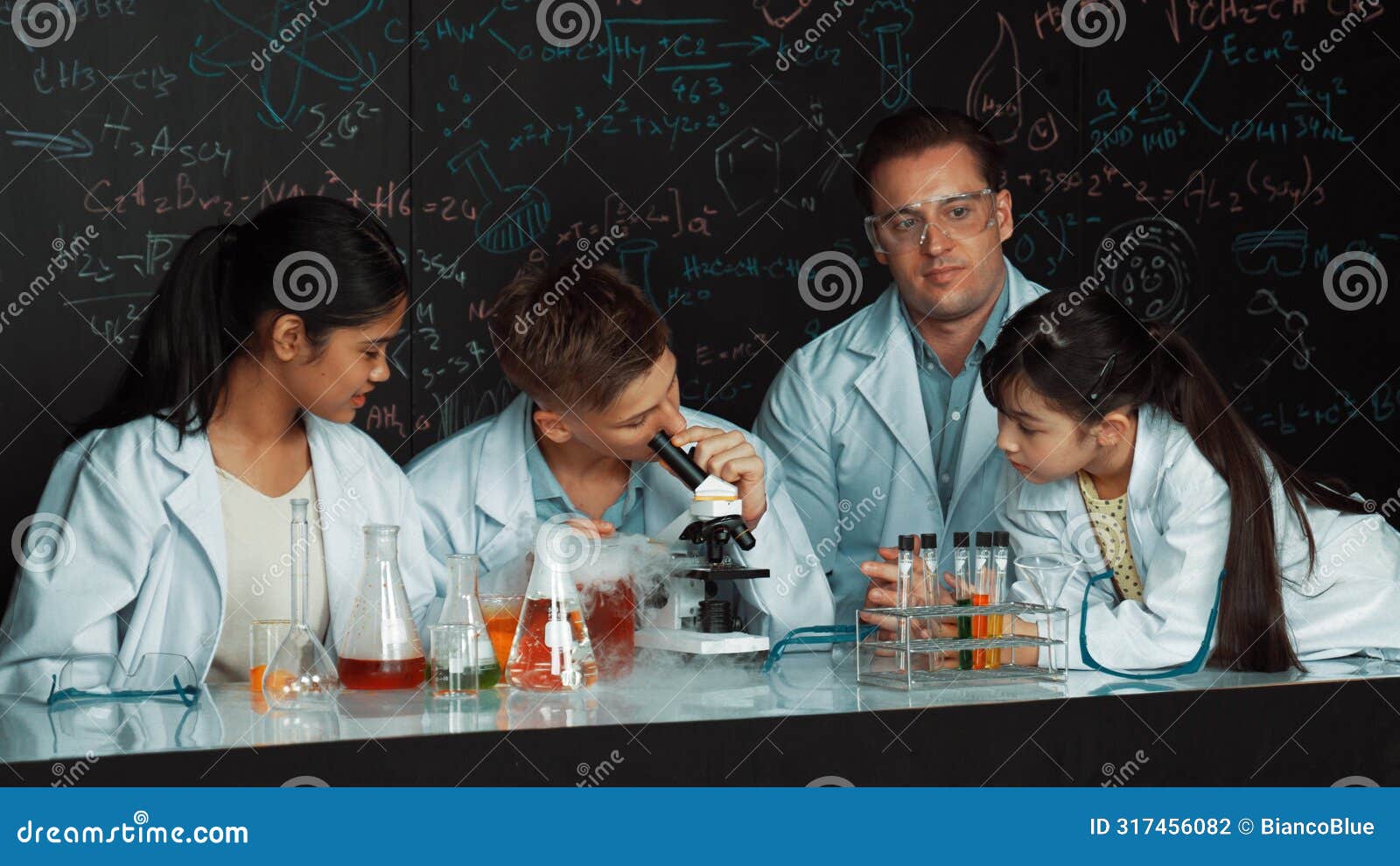 Student Looking Under Microscope while Cute Girl Inspect Sample ...