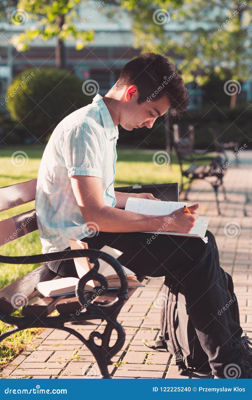 Student Making the Notes Sitting on a Bench in the Park Stock Photo ...