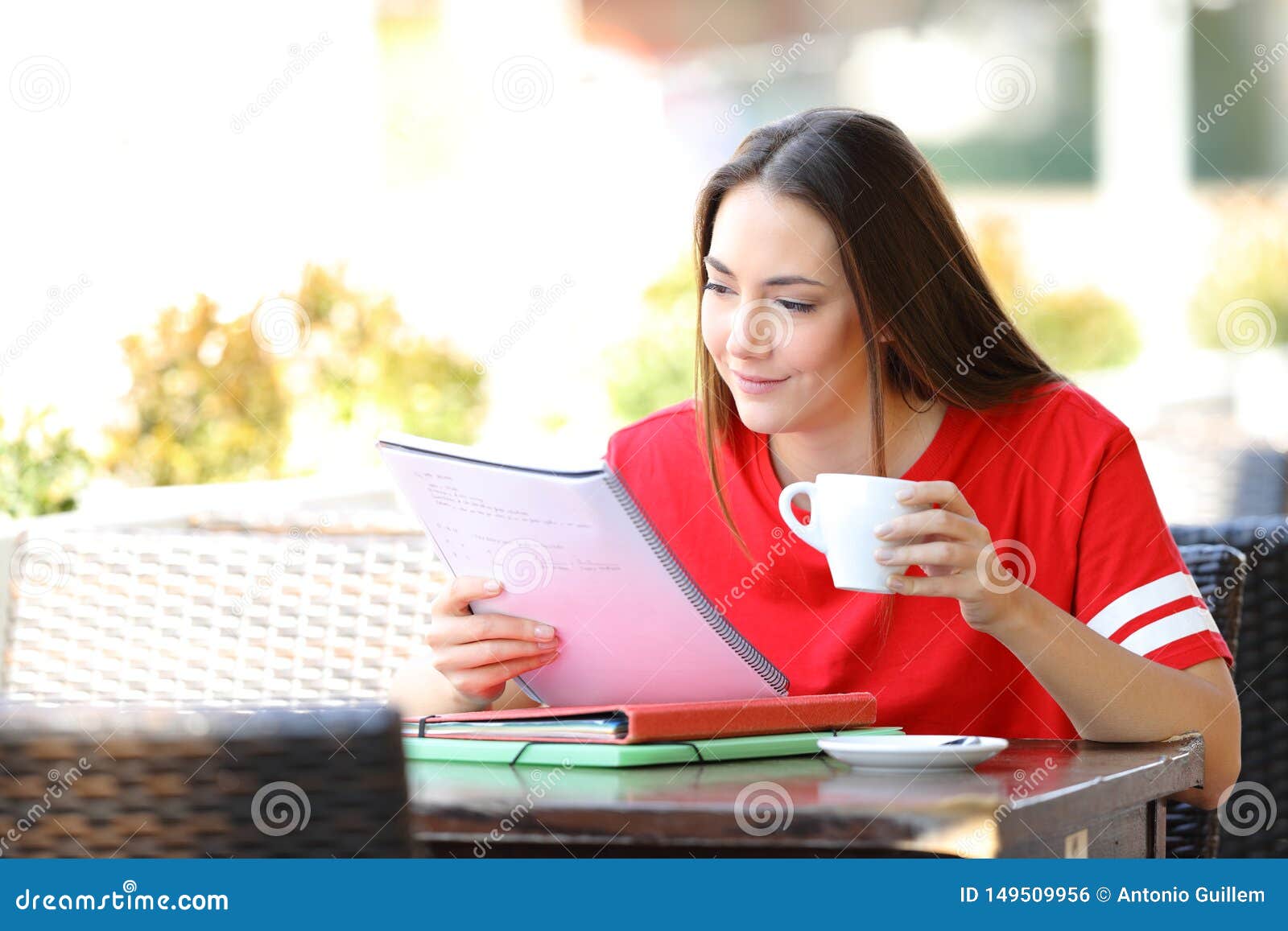 Student Memorizing Notes Holding a Coffee Cup in a Bar Stock Photo ...