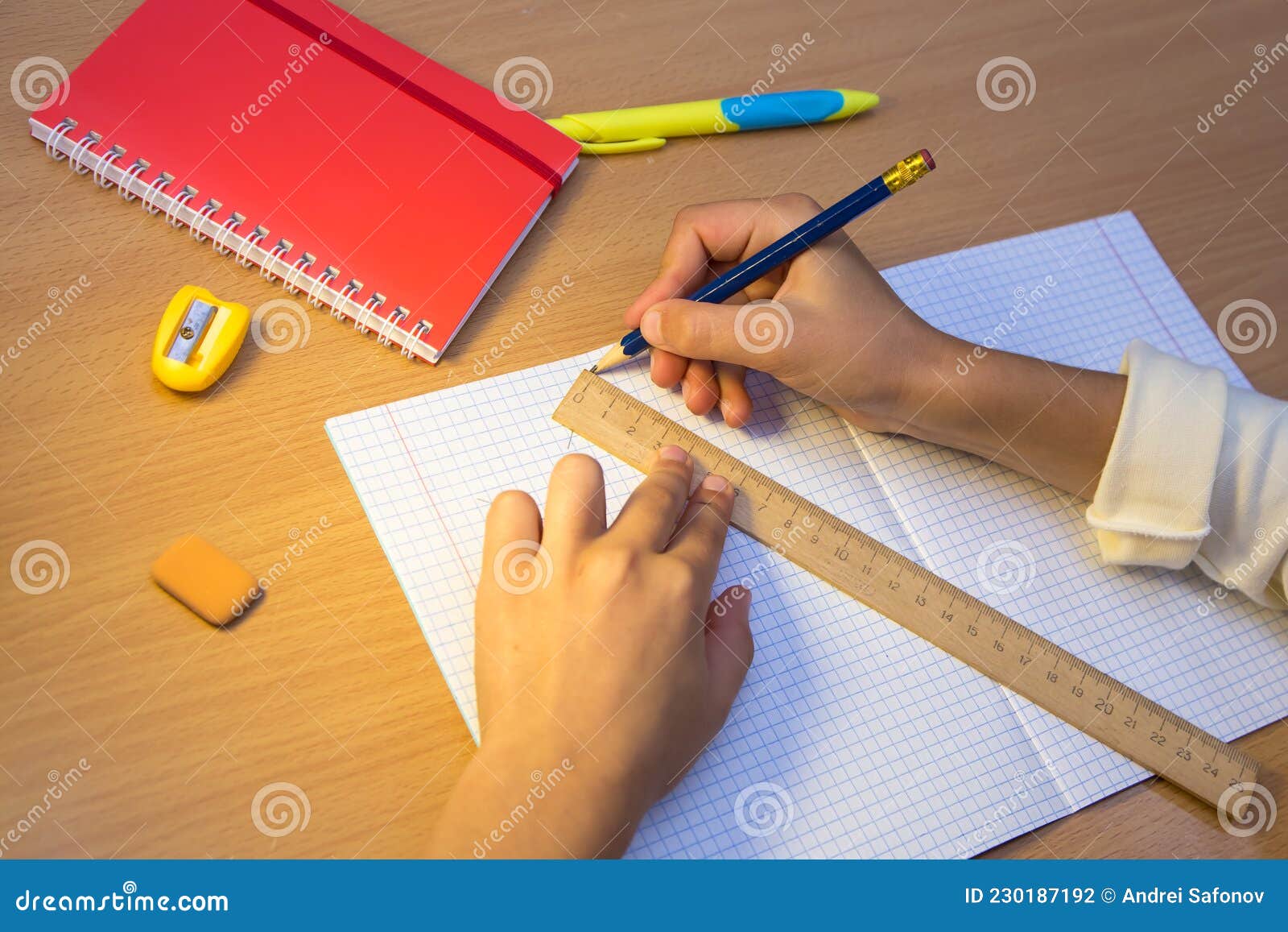 A Student in a Notebook Draws a Figure with a Pencil Along a Ruler ...