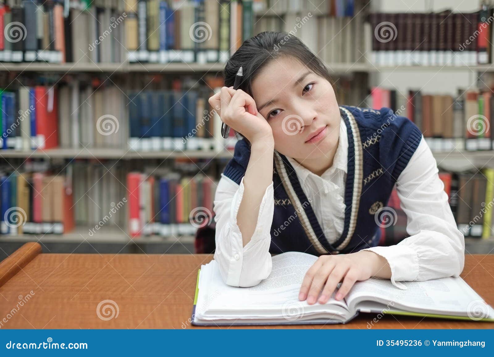 Student with Open Textbook Deep in Thought Stock Photo - Image of hand ...