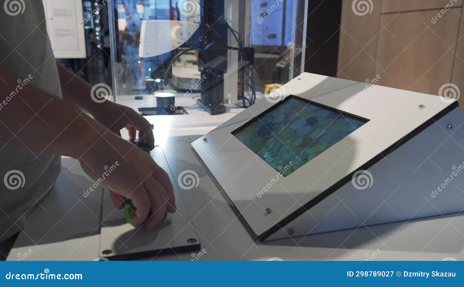 A Student Operates an Electron Microscope and Looks at the Results on a ...
