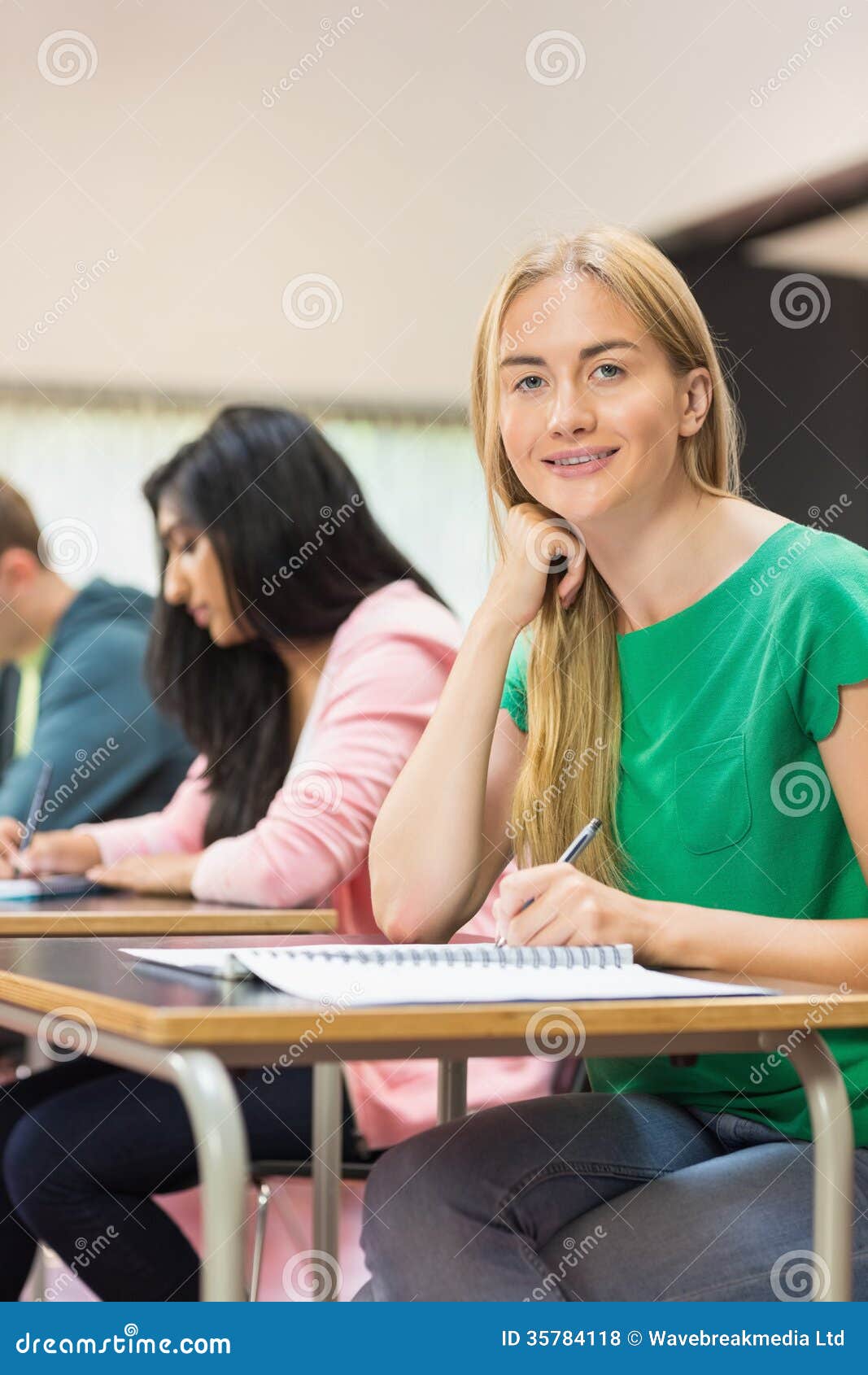 Student with Others Writing Notes in Classroom Stock Photo - Image of ...