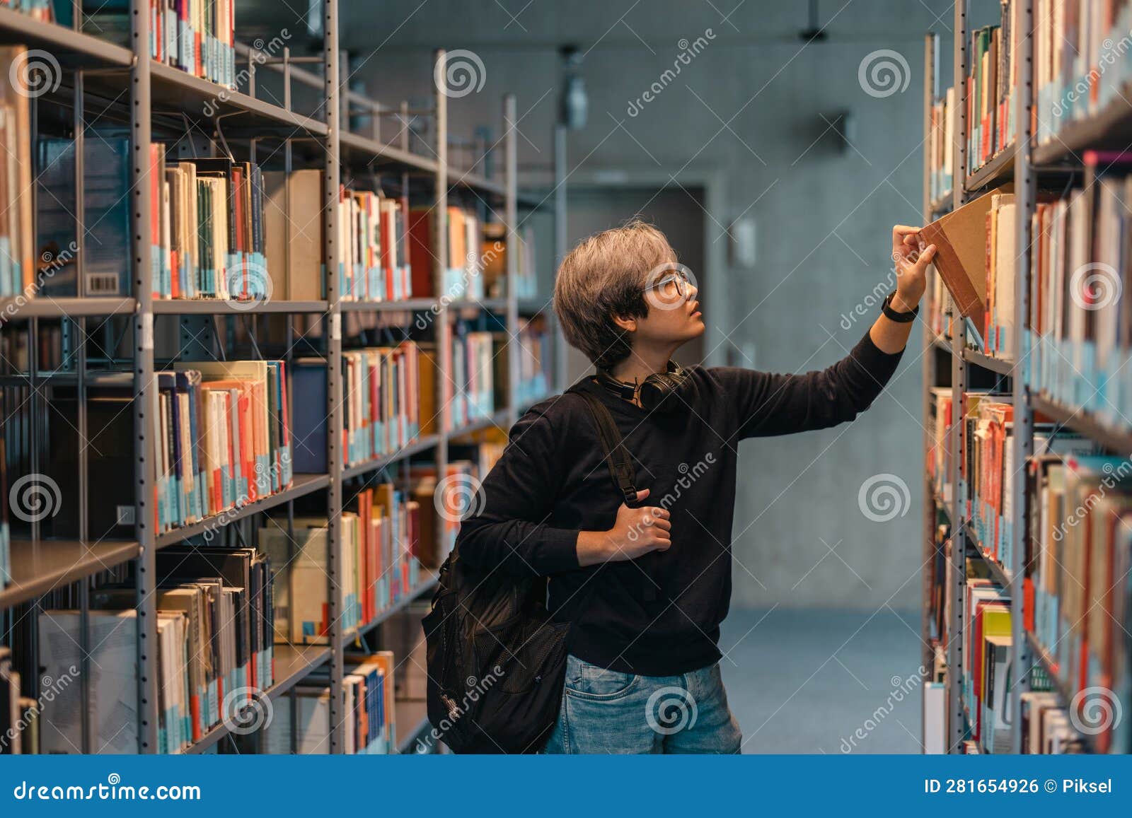 Student Picking Book from Bookshelf in Library Stock Photo - Image of ...