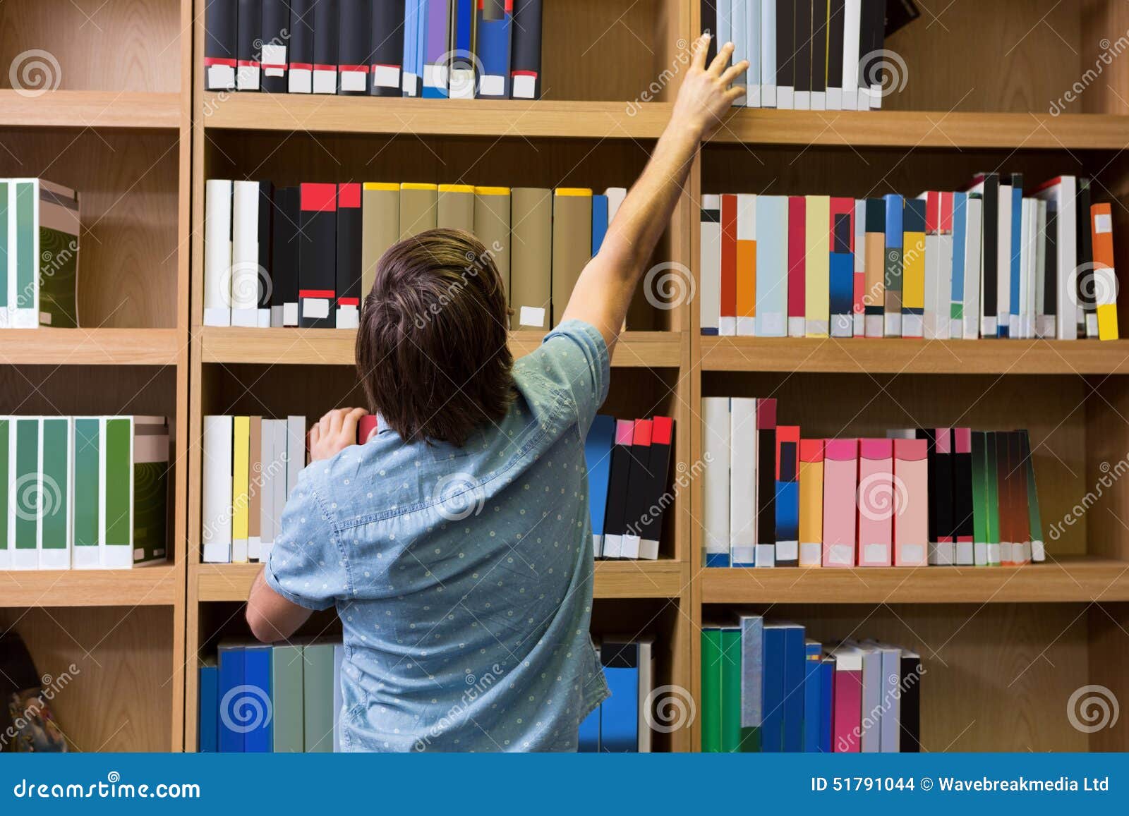 Student Picking a Book from Shelf in Library Stock Photo - Image of ...