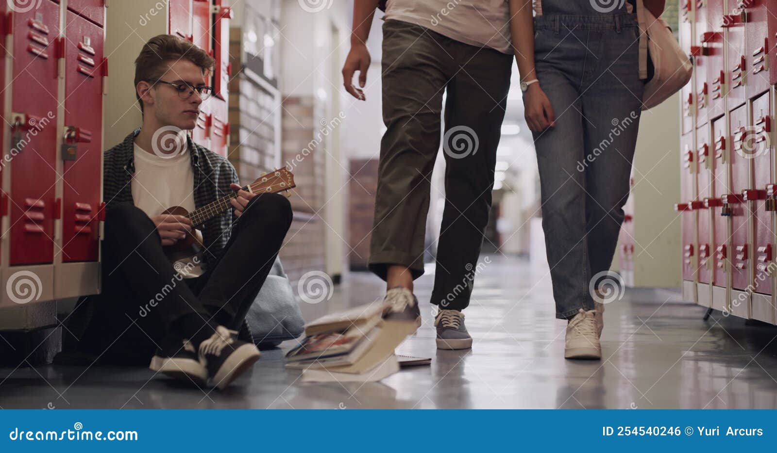Student Playing on a Ukulele with a School Bully Walking Past Him ...