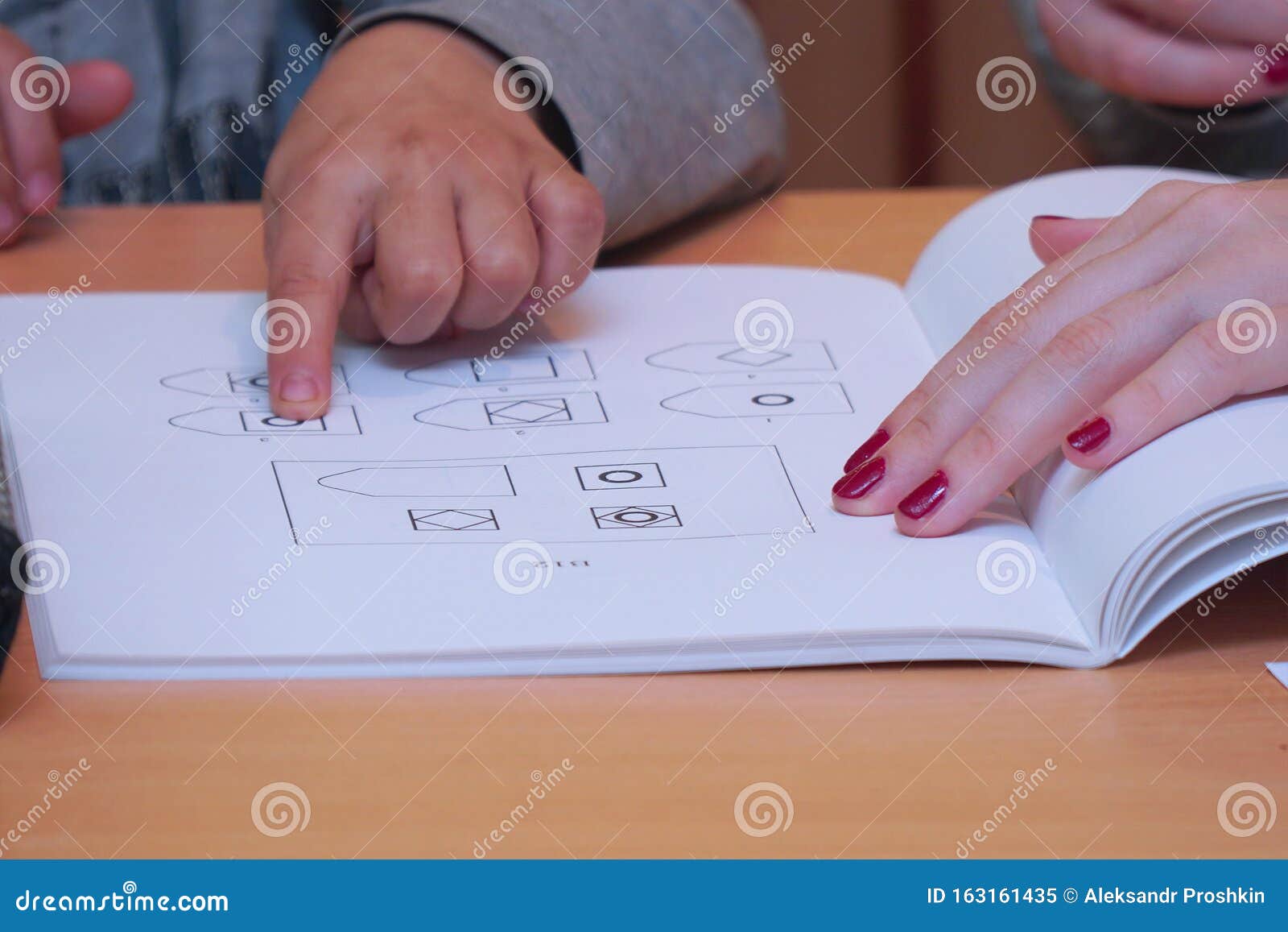 The Student Points a Finger at the Teacher at the Figures in the ...