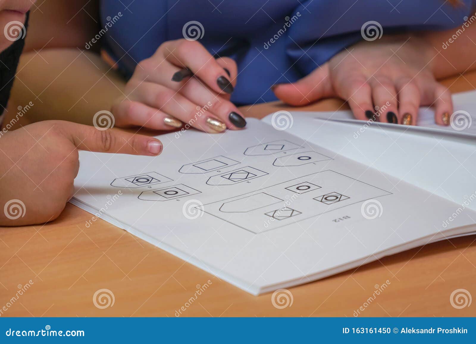 The Student Points a Finger at the Teacher at the Figures in the ...