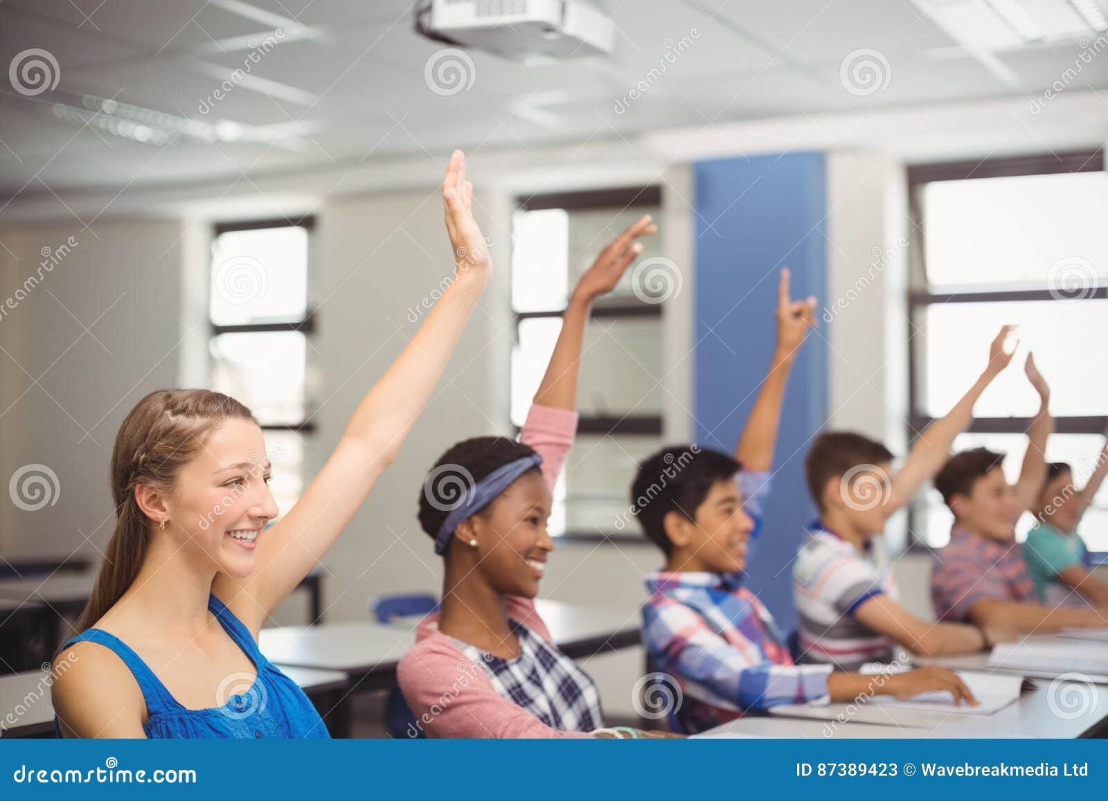 Student Raising Hand in Classroom Stock Image - Image of intelligent ...