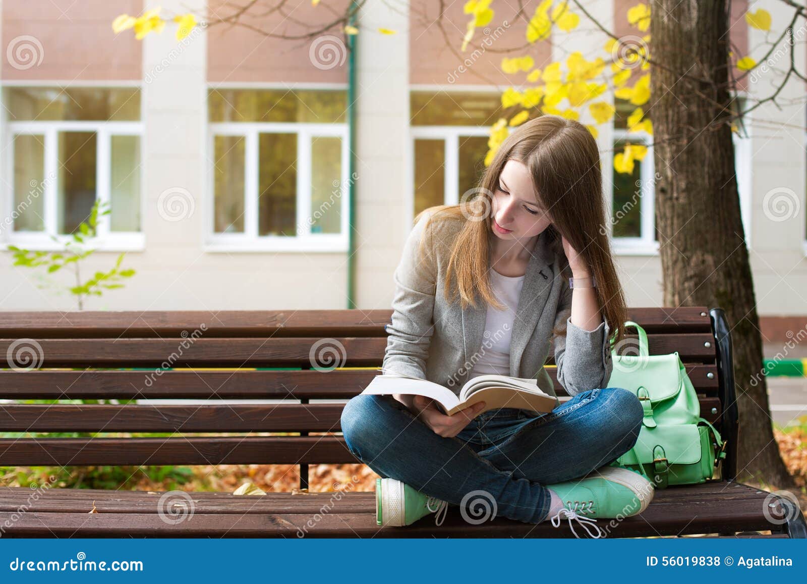 Student Reading Book on Bench Stock Photo - Image of nature, foreign ...