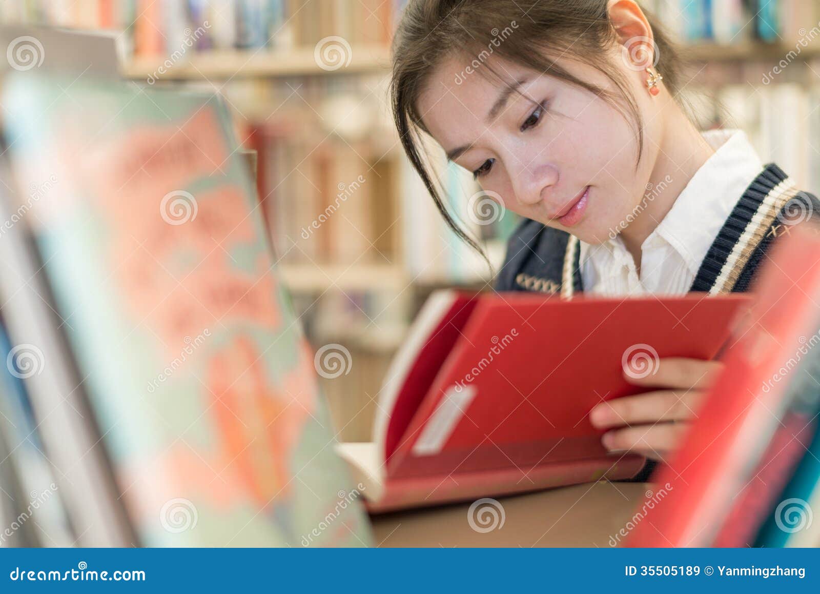 Student Reading a Book on Bookshelf Stock Image - Image of contemporary ...