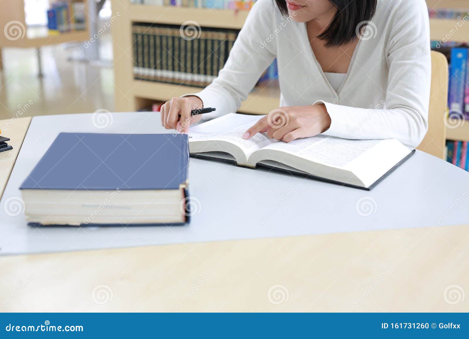 Student Reading Book in the Library at University Stock Photo - Image ...