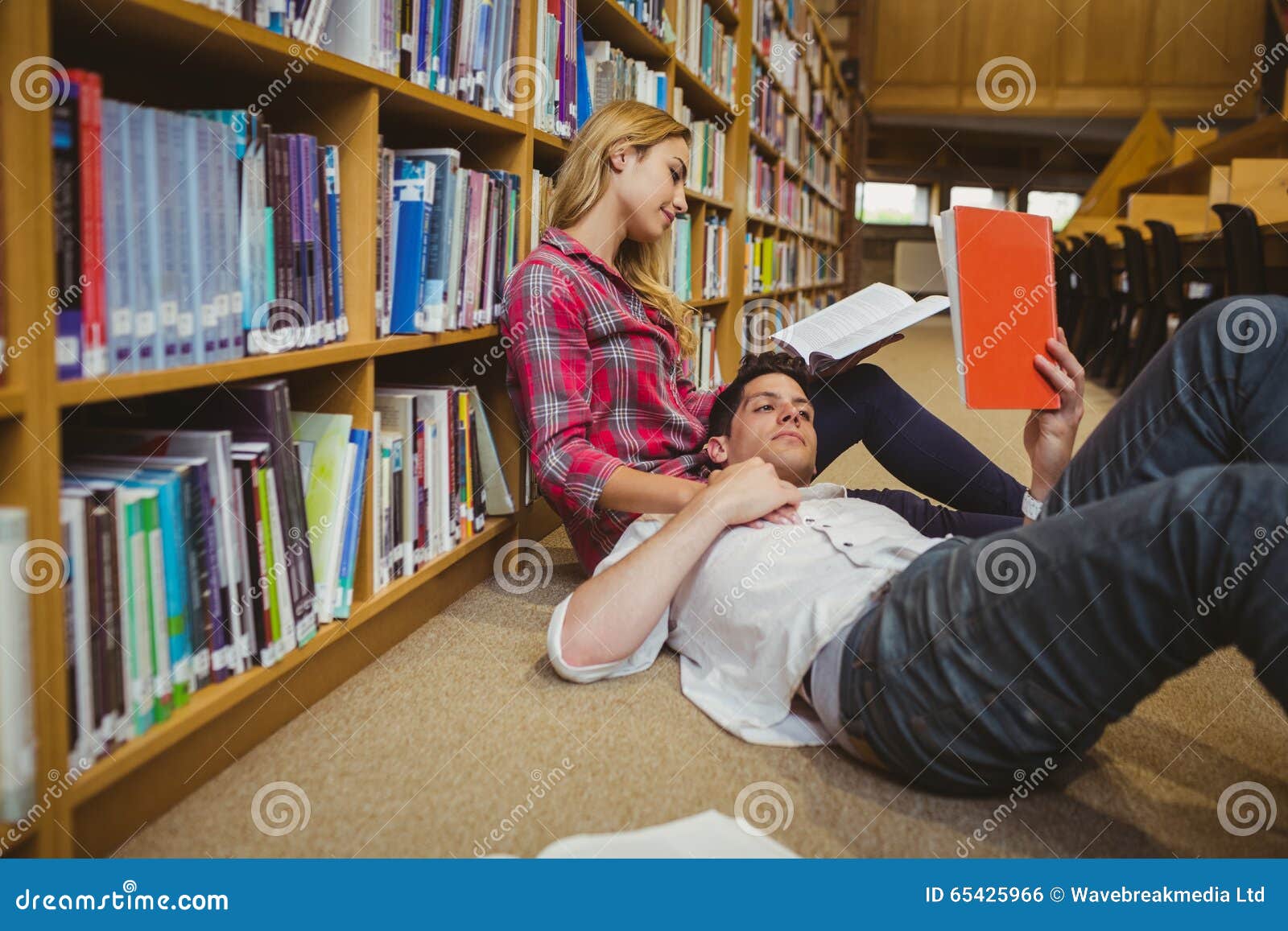 Student Reading Book while Lying on His Classmate Stock Photo - Image ...