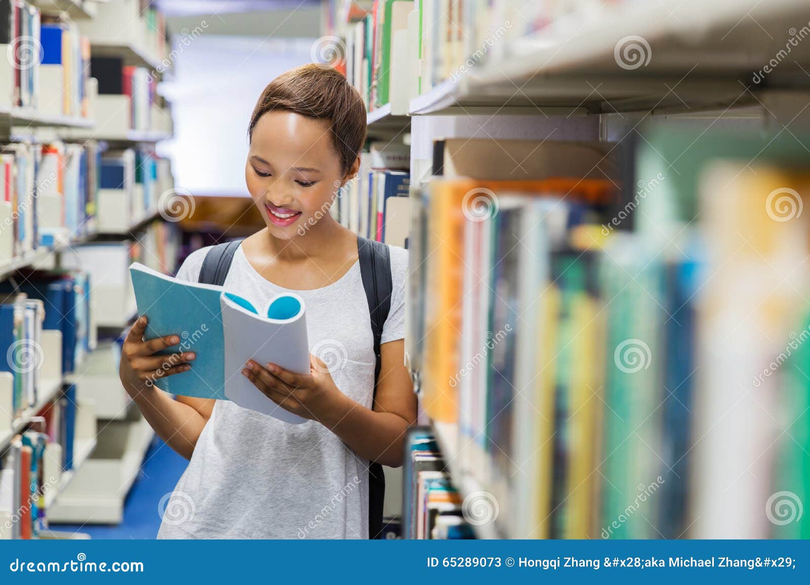 Student reading a book stock image. Image of person, librarian - 65289073