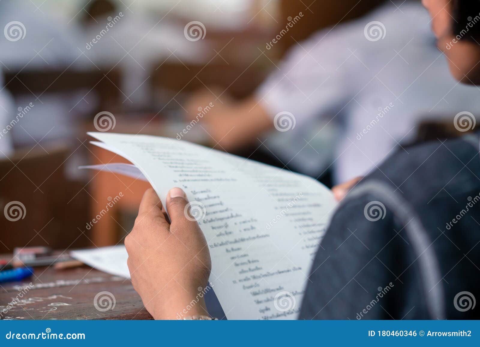 Student Reading and Doing Test or Exam in Classroom of School with ...