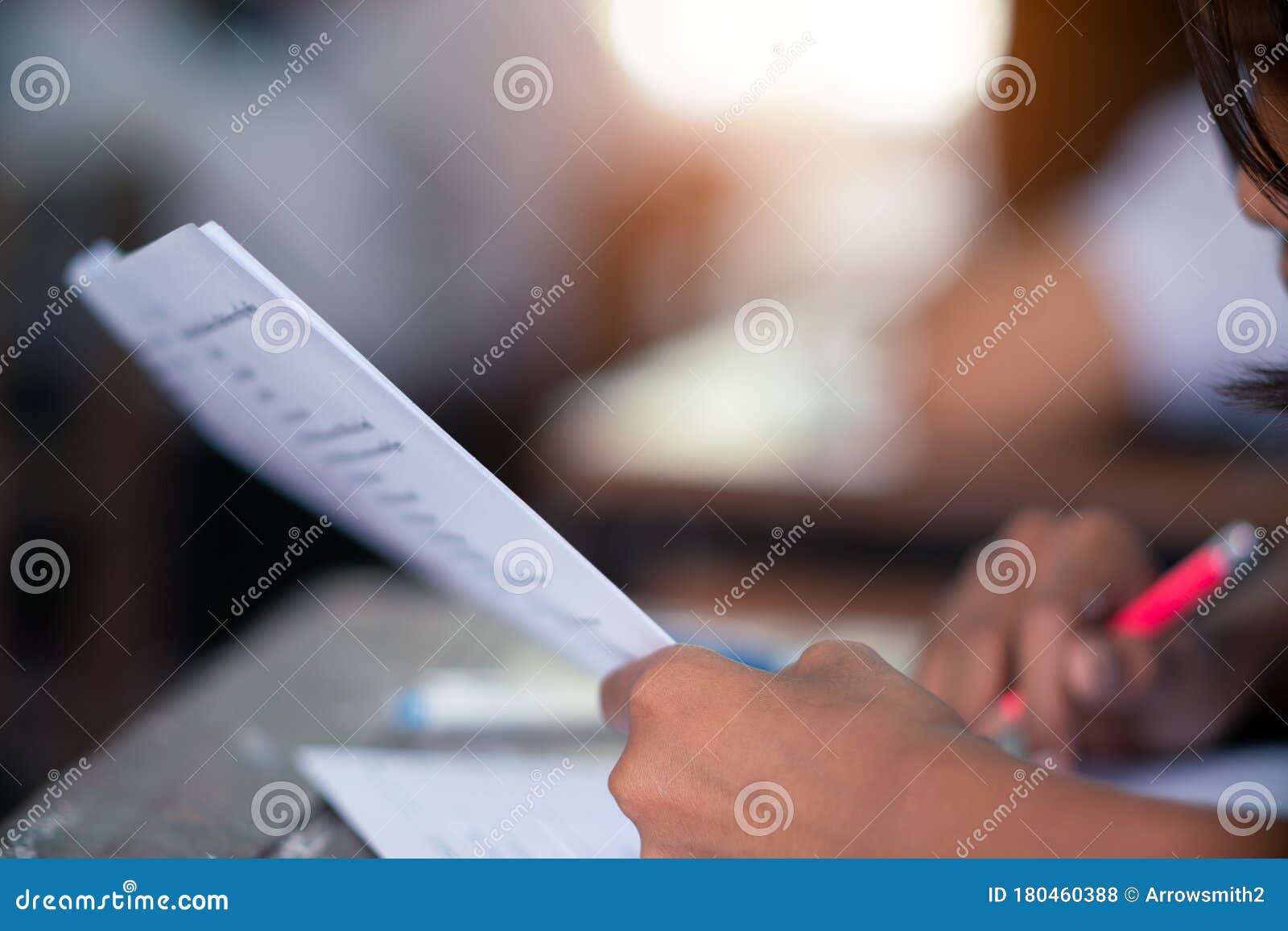 Student Reading and Doing Test or Exam in Classroom of School with ...