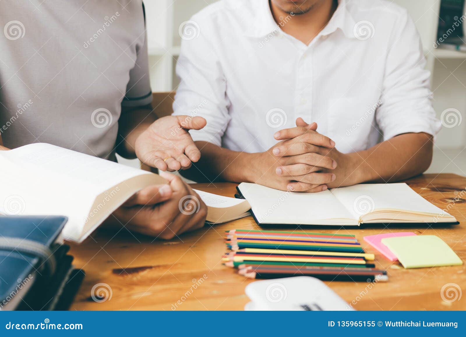 Student Reading Textbook for Test Together in Library Stock Image ...