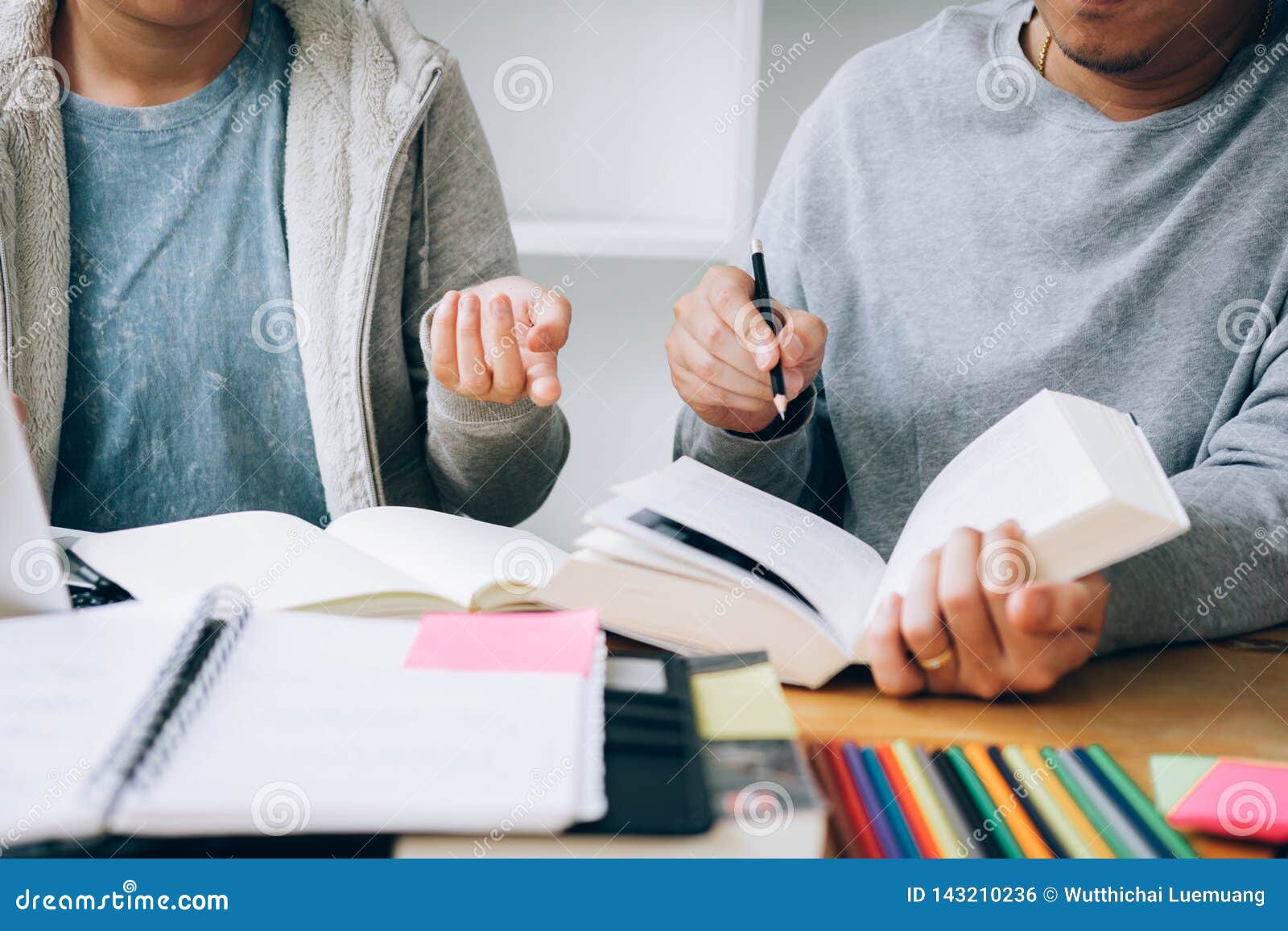 Student Reading Textbook for Test Together in Library Stock Photo ...