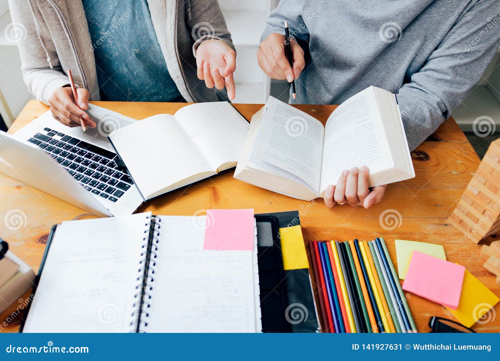 Student Reading Textbook for Test Together in Library Stock Image ...