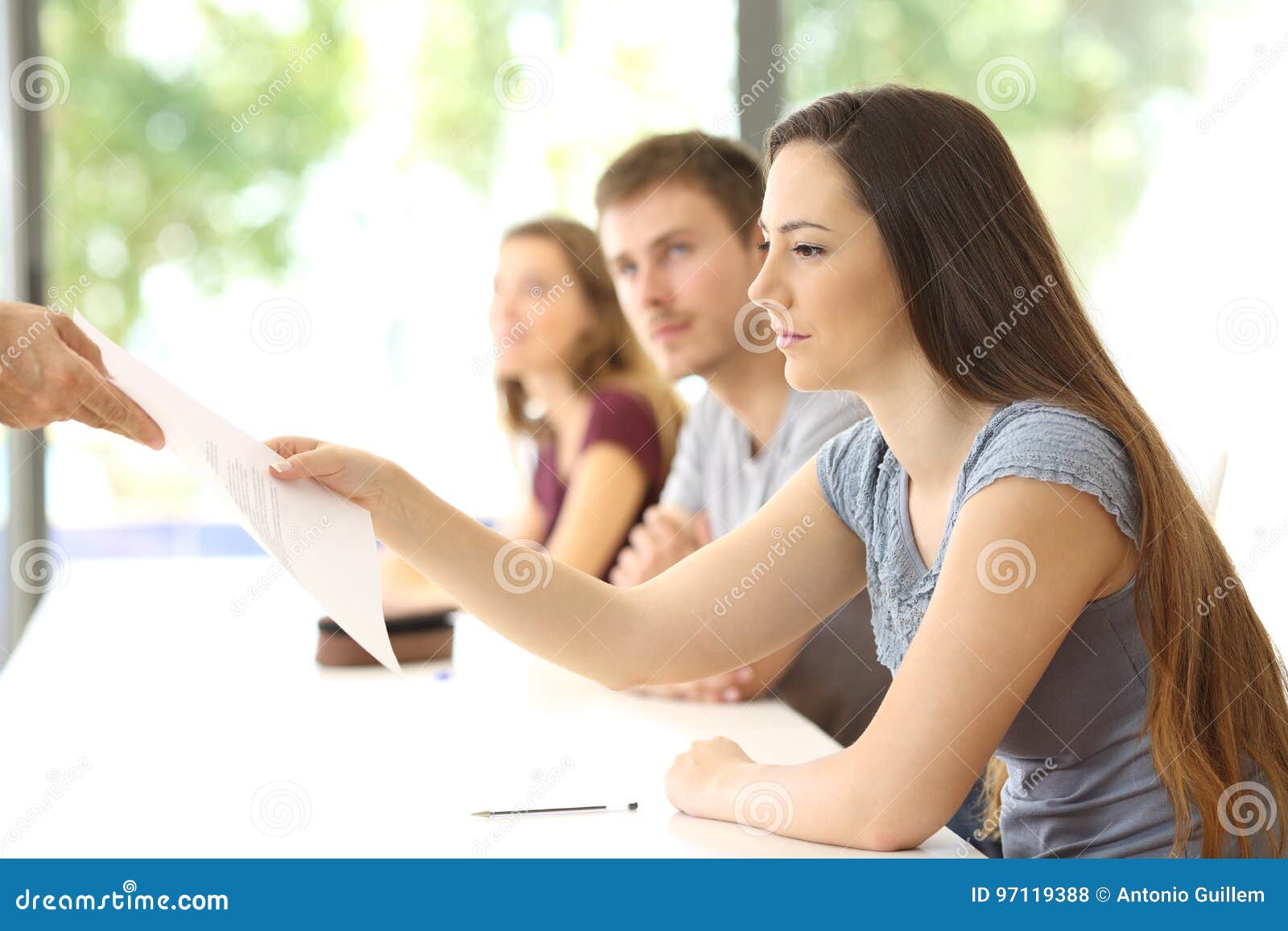 Student Receiving an Exam from the Teacher Stock Photo - Image of ...