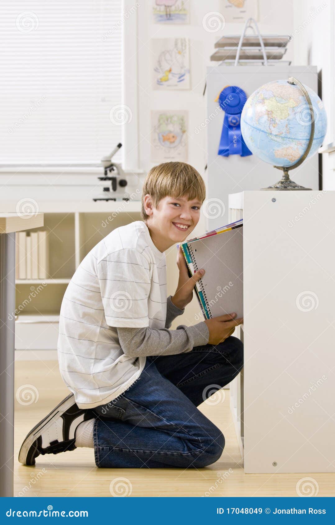 Student Removing Books from Shelf Stock Image - Image of caucasian ...