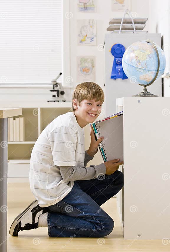 Student Removing Books from Shelf Stock Image - Image of caucasian ...
