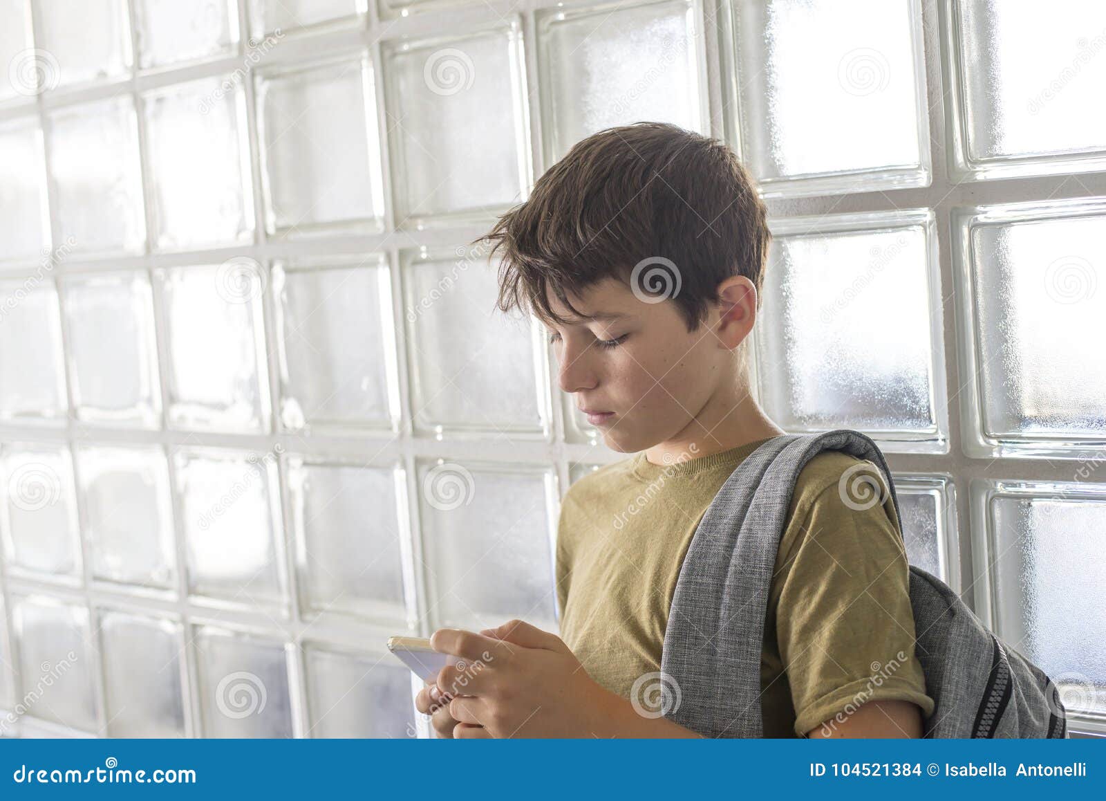 Student Resting on the School and Playing with a Mobile Phone Stock ...