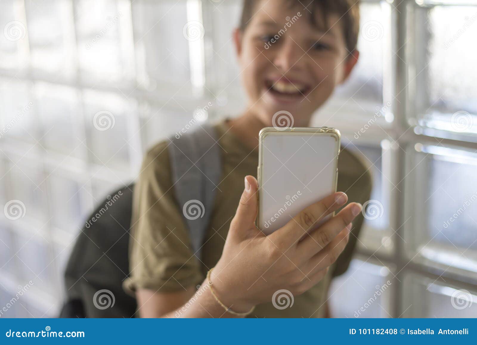 Student Resting on the School and Playing with a Mobile Phone Stock ...