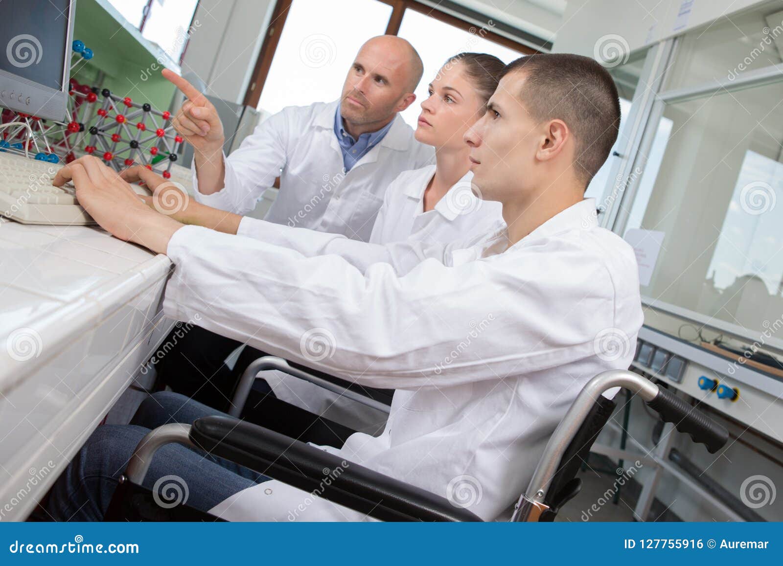 Student Scientists Sat Around Computer One in Wheelchair Stock Photo ...