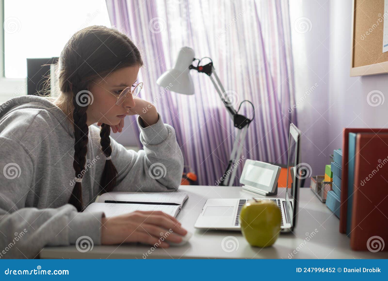 The Teen is Studying Remotely Via the Internet Using a Laptop. Stock ...