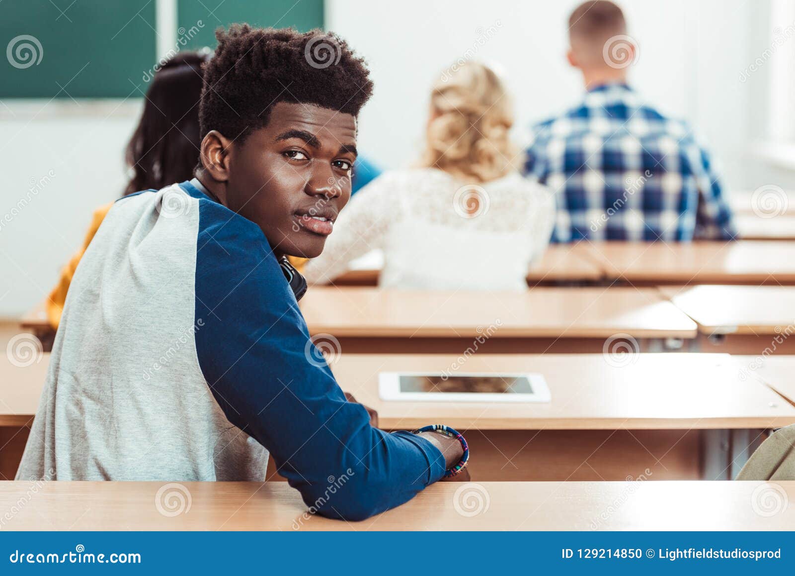 African American Student Sitting in Classroom and Looking Back Stock ...