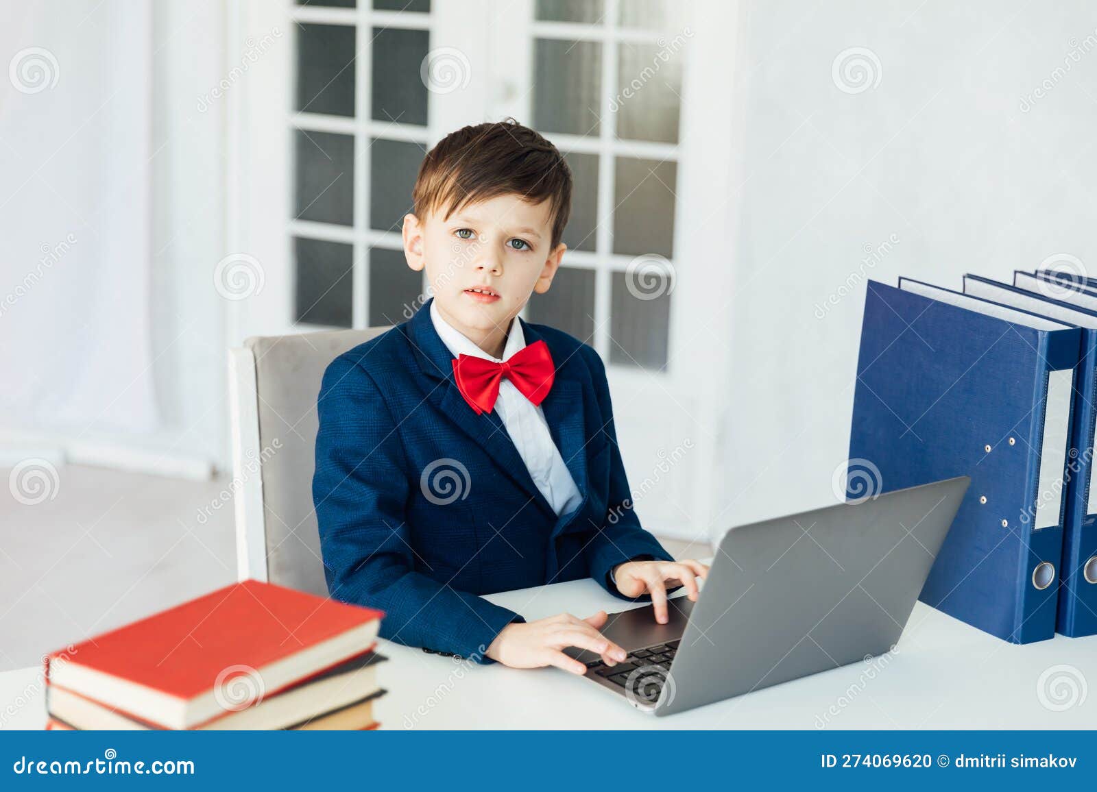 Student Sitting in the Classroom at a Laptop with Books in the Office ...