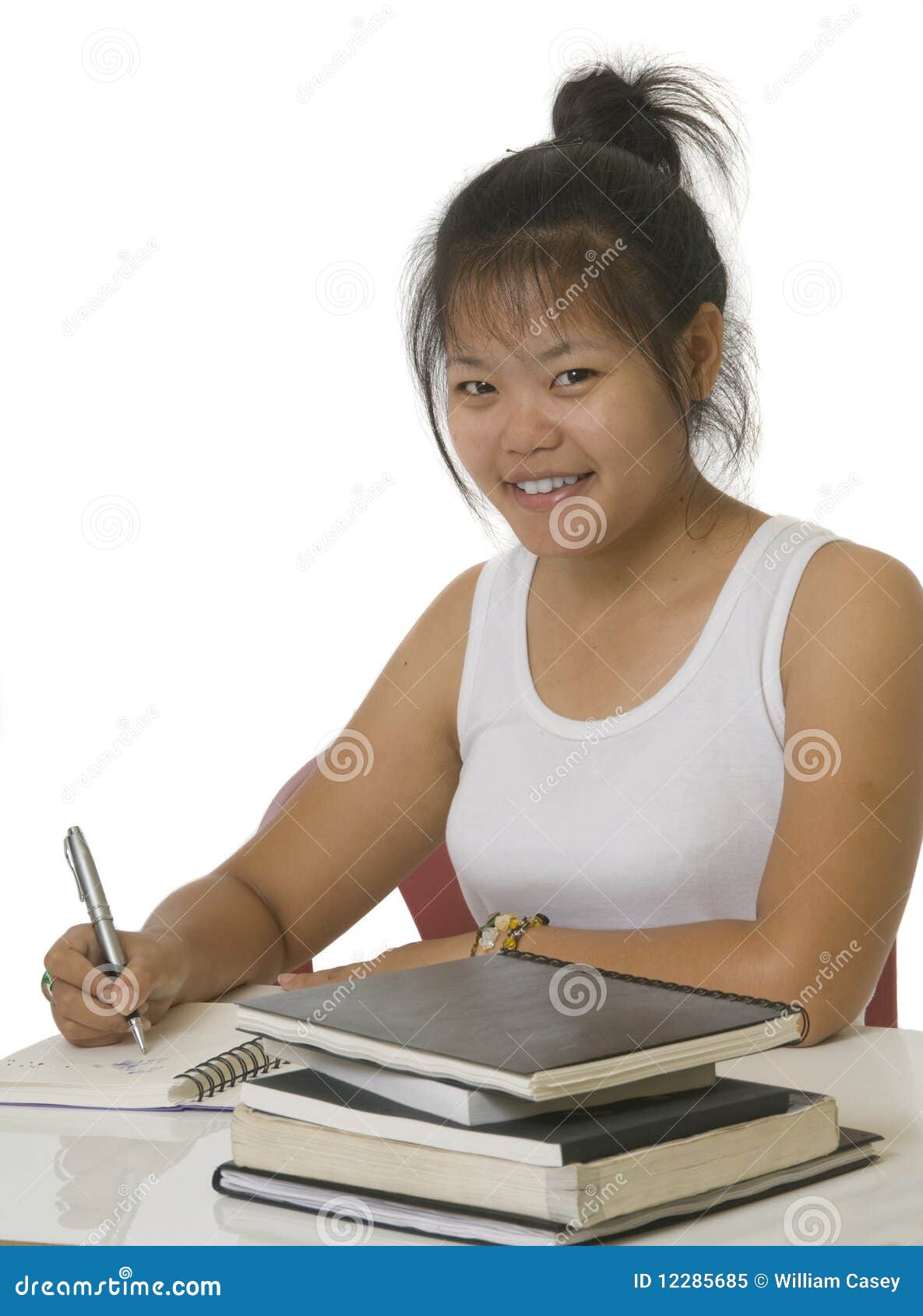 Student Sitting Down at Desk and Doing Homework Stock Image - Image of ...