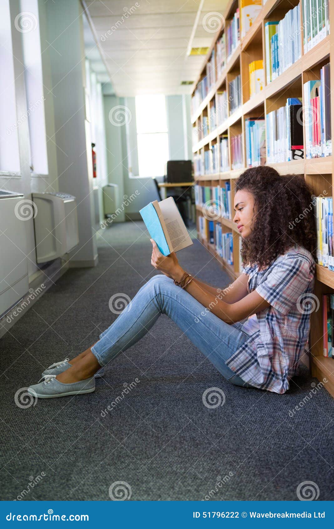 Student Sitting on Floor in Library Reading Stock Photo - Image of ...