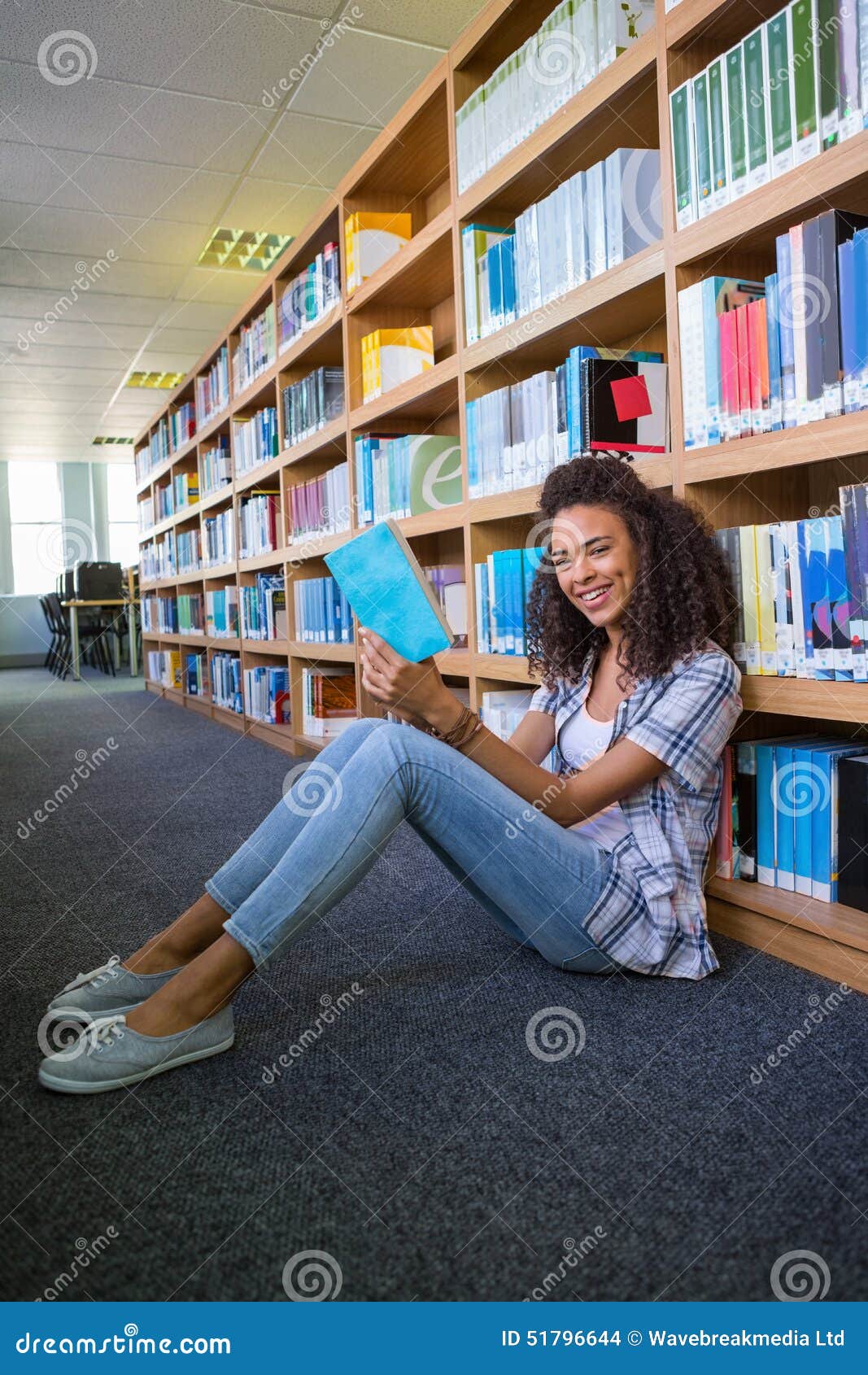 Student Sitting on Floor in Library Reading Stock Photo - Image of ...