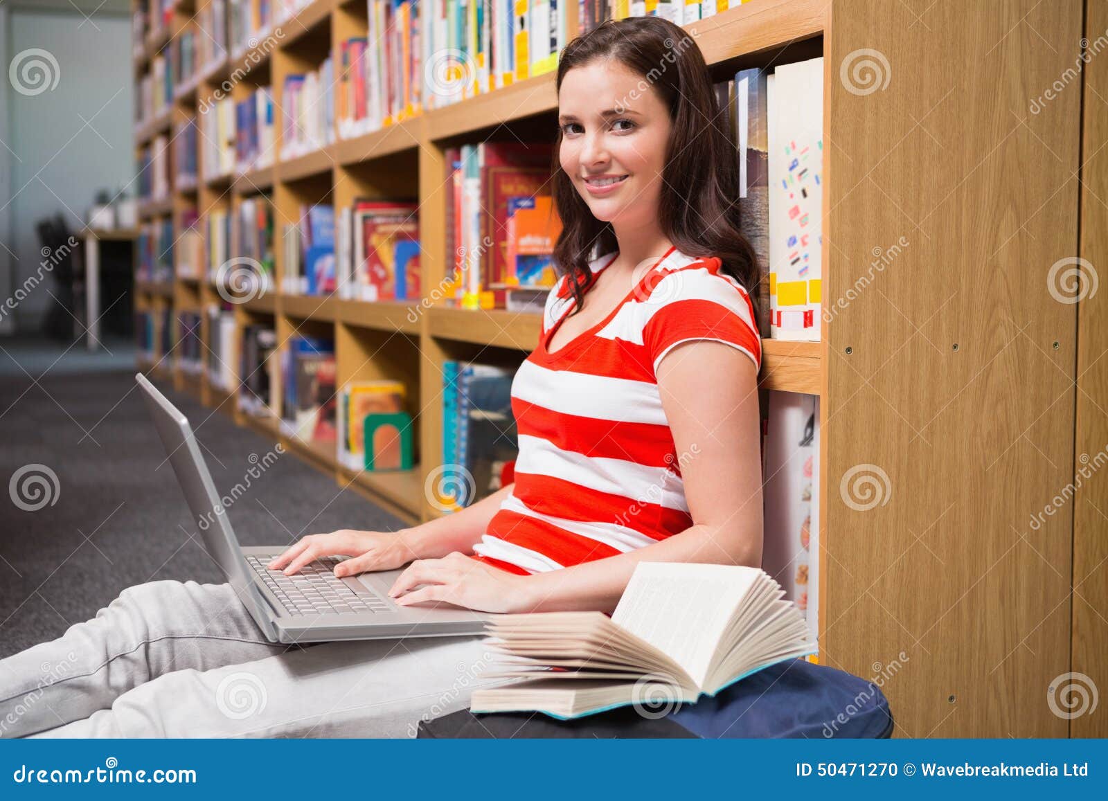 Student Sitting on Floor in Library Using Laptop Stock Photo - Image of ...