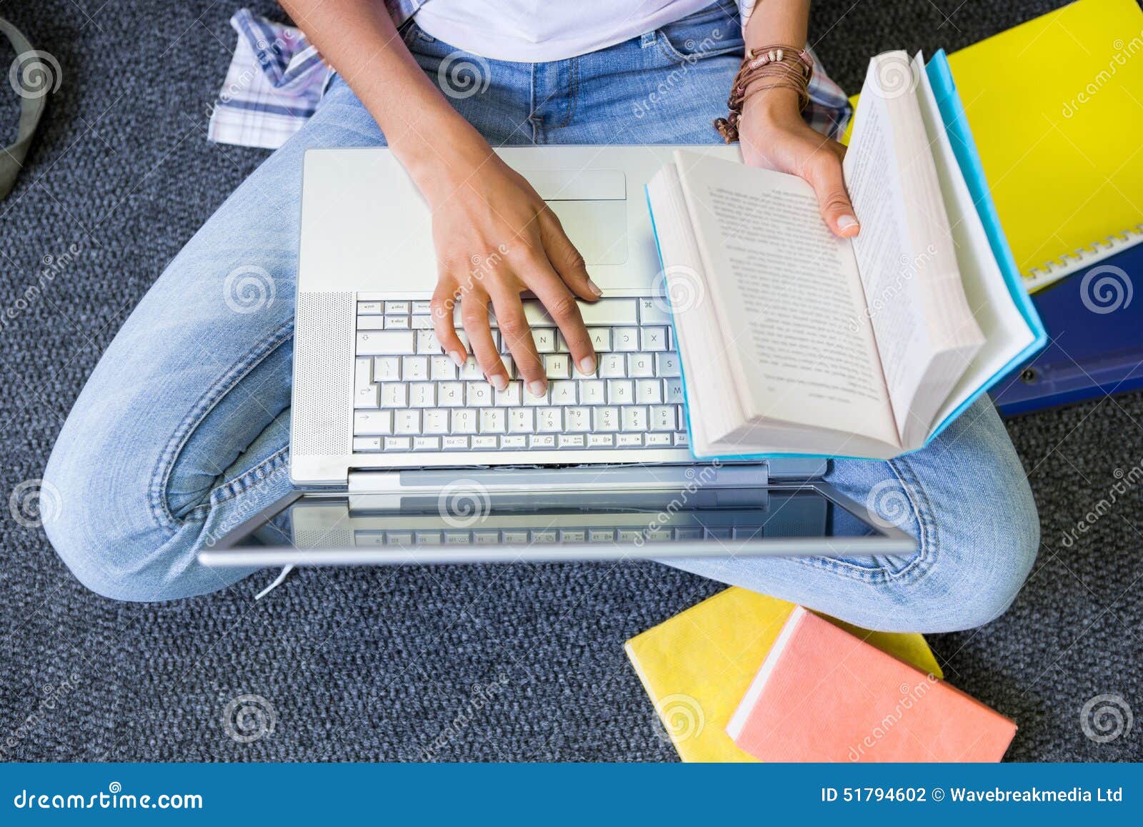 Student Sitting on Floor in Library Using Laptop Stock Photo - Image of ...
