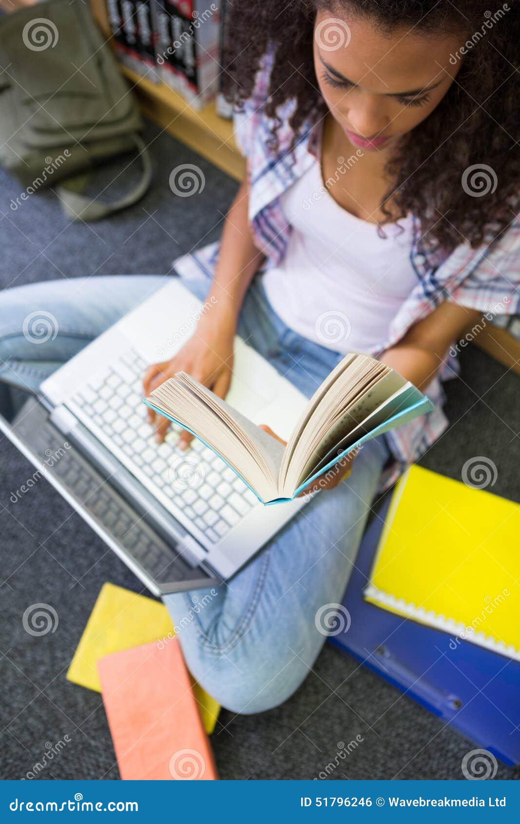 Student Sitting on Floor in Library Using Laptop Stock Photo - Image of ...
