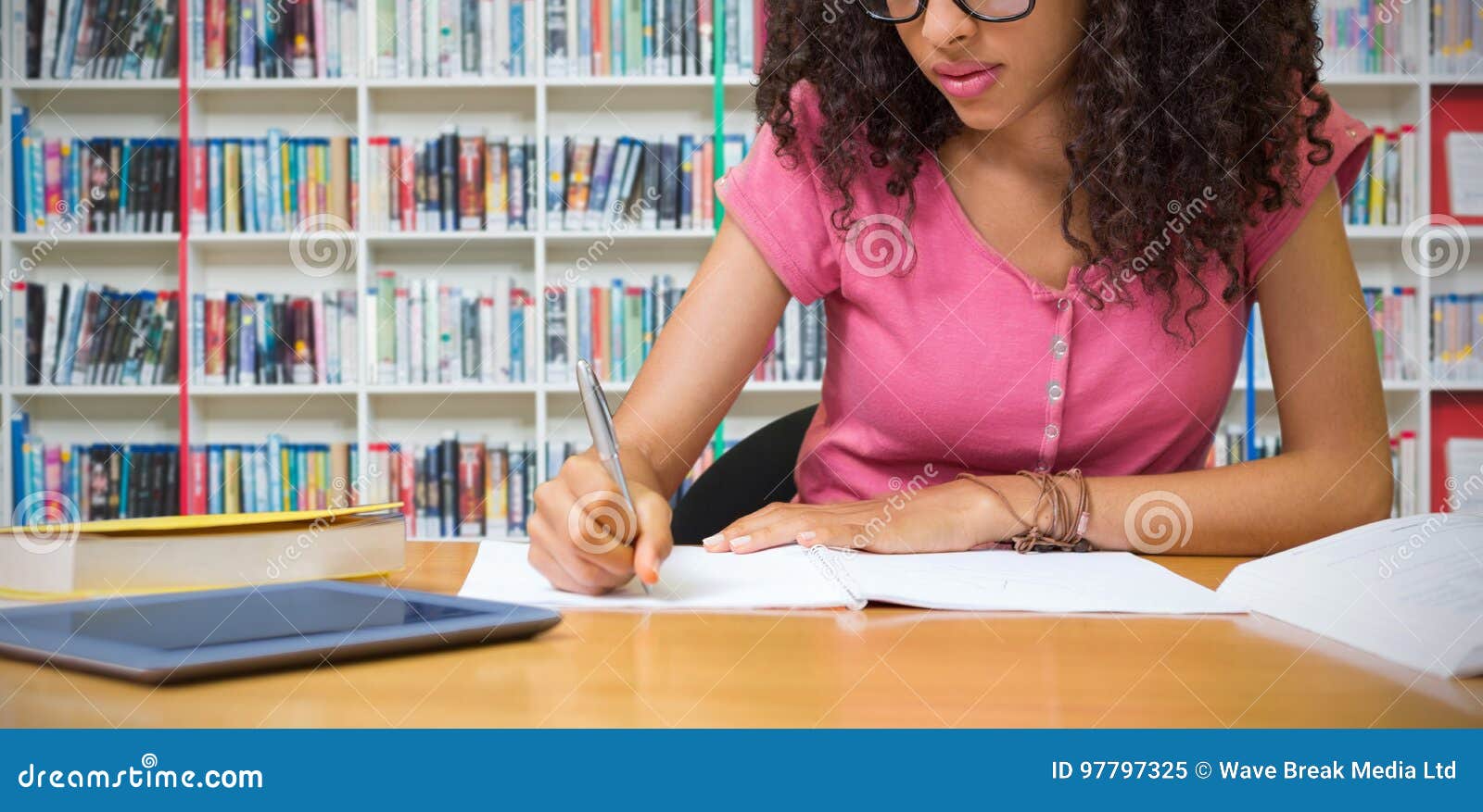 Composite Image of Student Sitting in Library Writing Stock Image ...