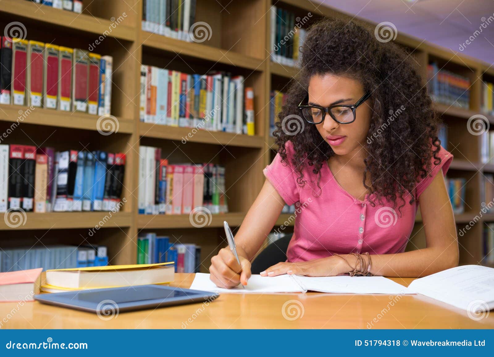 Student Sitting in Library Writing Stock Photo - Image of book, student ...